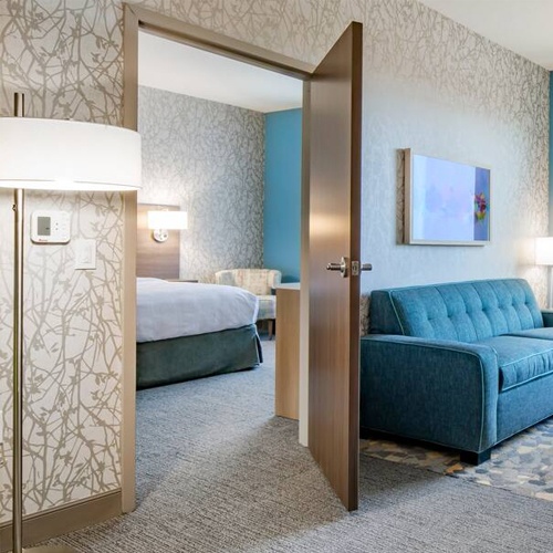 swing flush wood door in bedroom of Home2 Suites